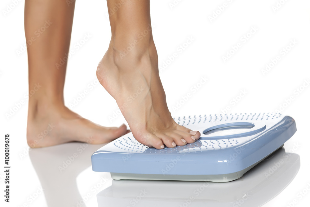 female feet on scale Stock Photo | Adobe Stock