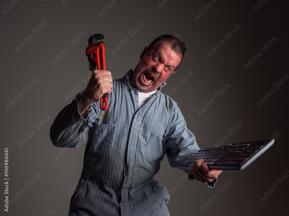 Foto de Stock Photograph of an angry repairman hollering and about to ...