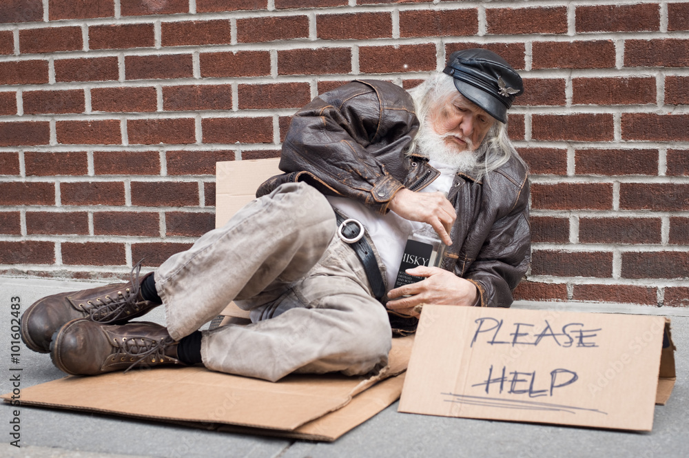Foto de Stock Homeless man sitting on a street with sign.Homeless lying ...