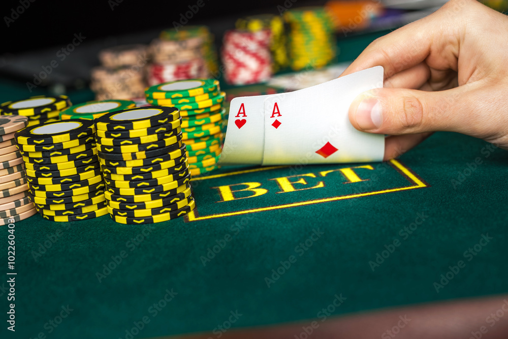 Male poker player lifting the corners of two cards aces Stock Photo ...