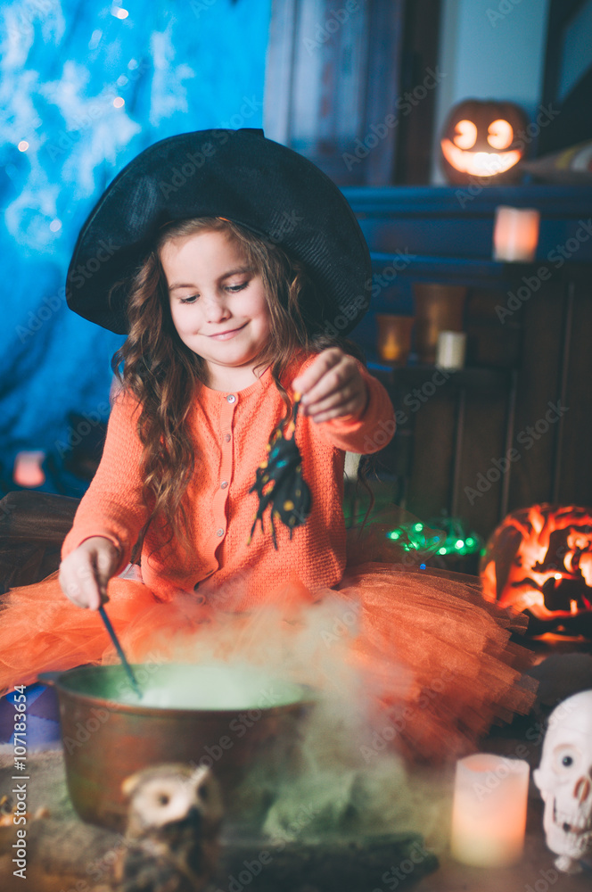 Little girl in a costume of witch with magic wand and spider Stock ...