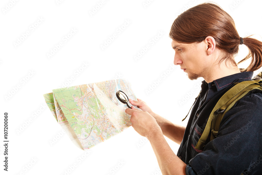 Man tourist reading map with magnifying glass Stock Photo | Adobe Stock