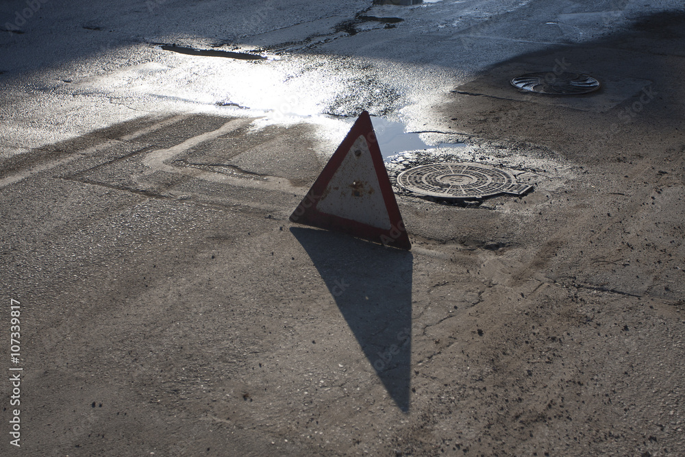 Road with hatches and a warning sign Stock Photo | Adobe Stock