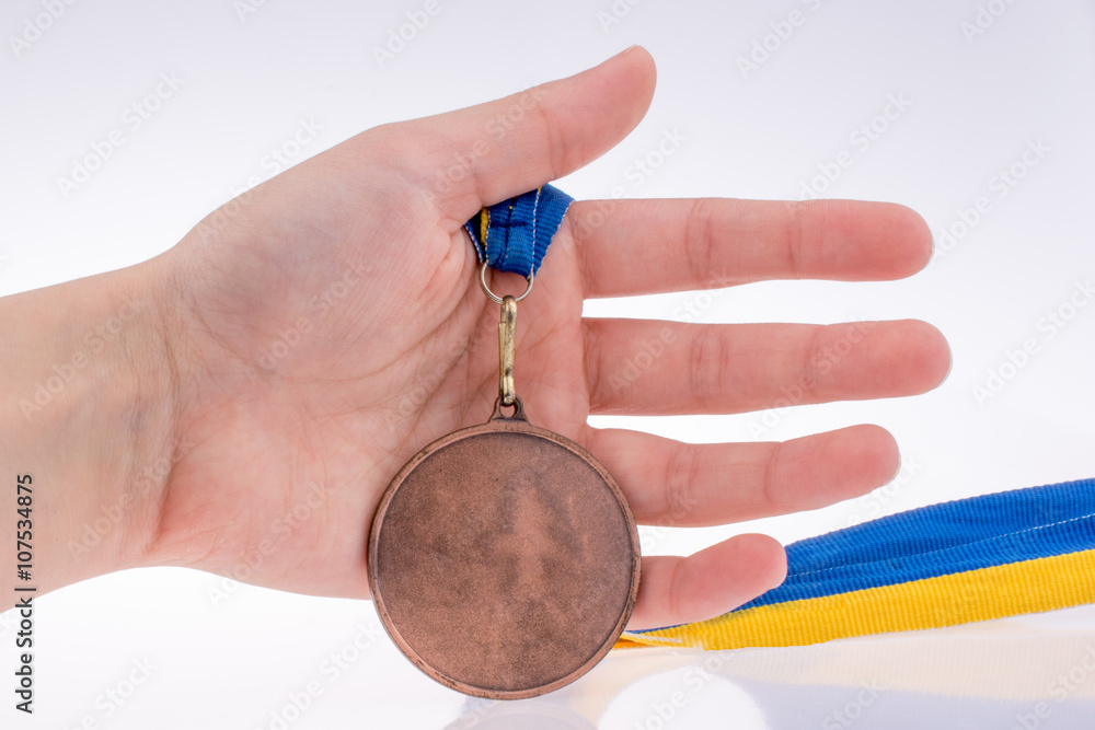 Hand holding medal Stock Photo | Adobe Stock