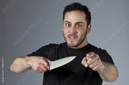an angry man holding a knife Stock Photo | Adobe Stock