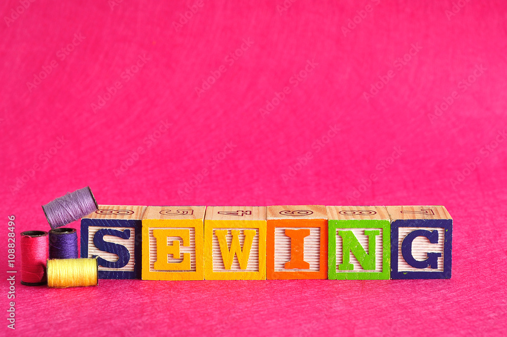 The word sewing spelled with colorful alphabet blocks displayed with ...