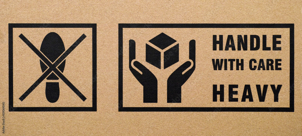Signs Do not step and Handle with care Heavy on cardboard box Stock ...
