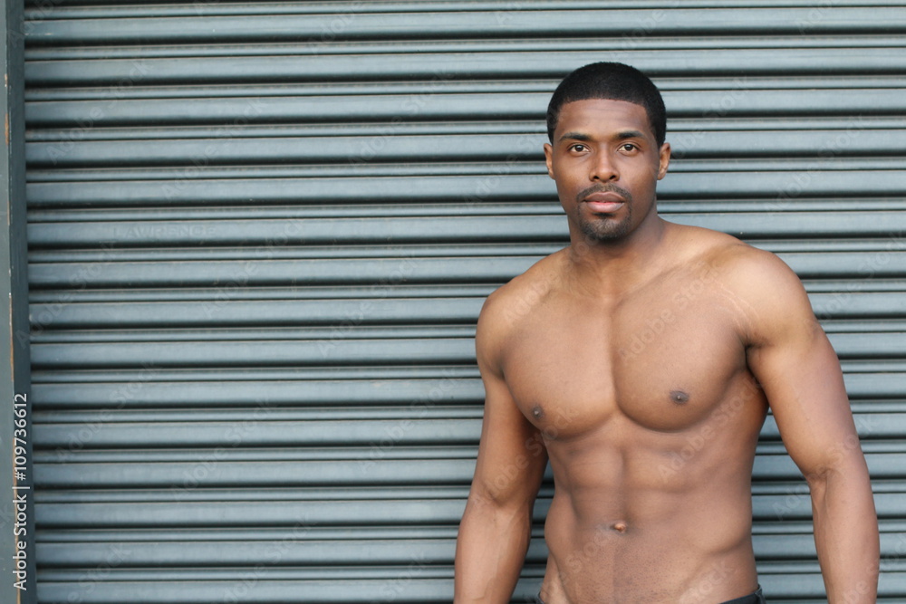 Portrait of a lean toned and ripped muscle fitness man under soft ...