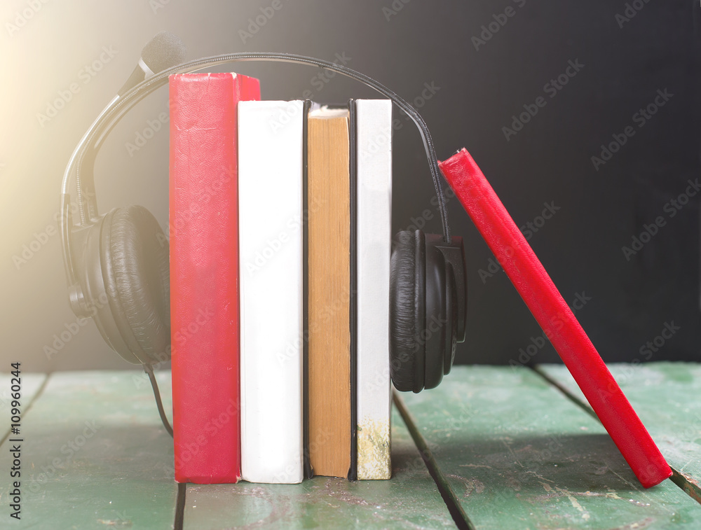 Books and ear plugs Stock Photo | Adobe Stock