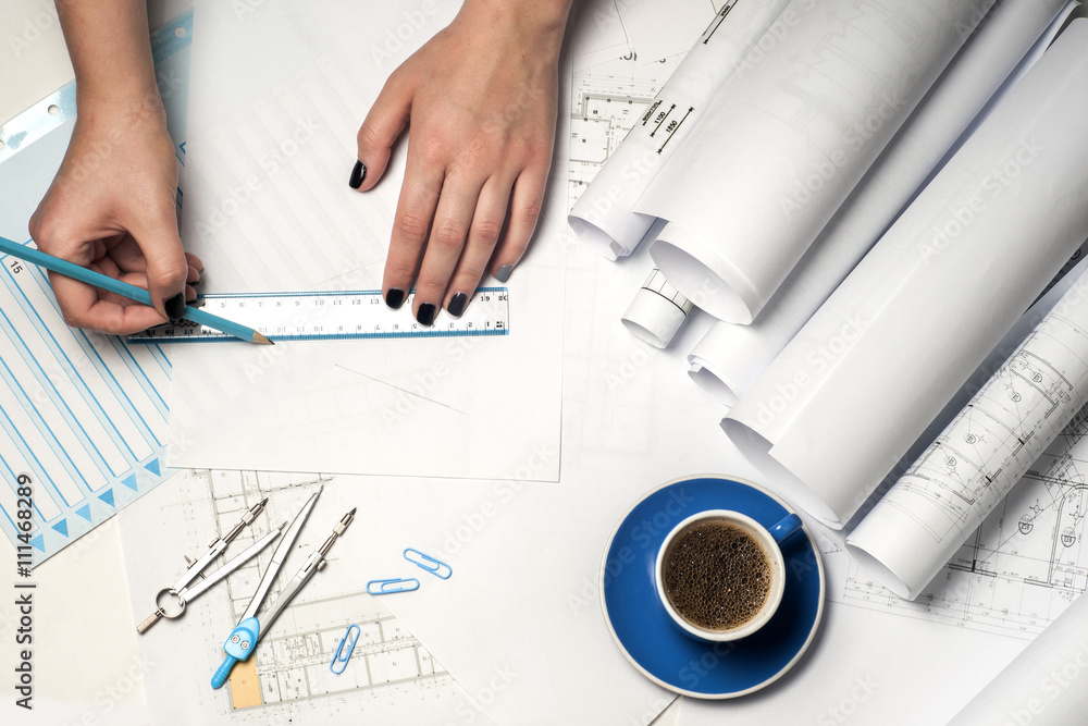 Architect working on blueprint. Architects workplace - architectural ...