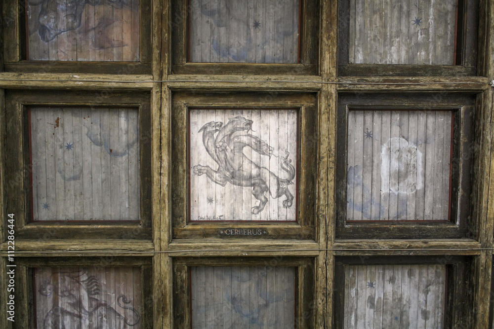Old wooden ceiling with caissons. Each caisson - a mystical image. In ...