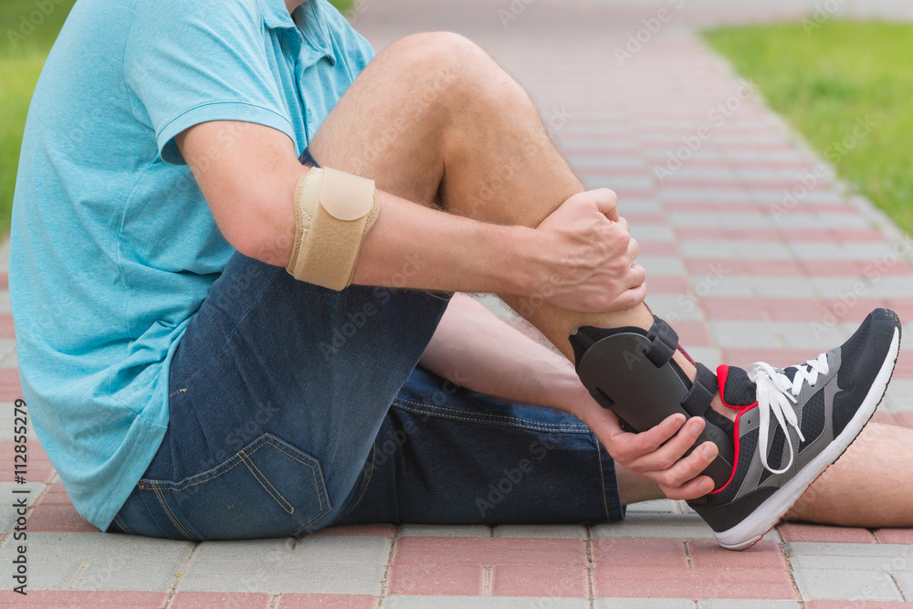 Man wearing ankle brace Stock Photo | Adobe Stock