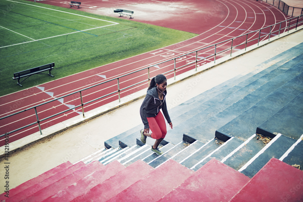 Female athlete running upstairs at stadium Stock Photo | Adobe Stock