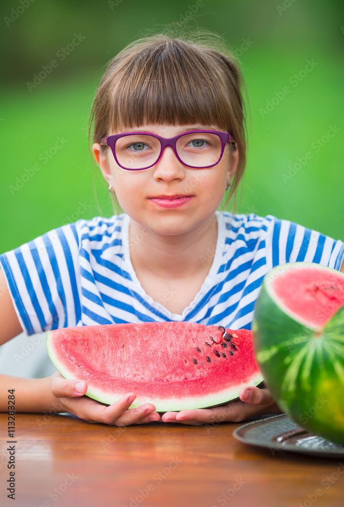 Child eating watermelon. Kids eat fruits in the garden. Pre teen girl ...