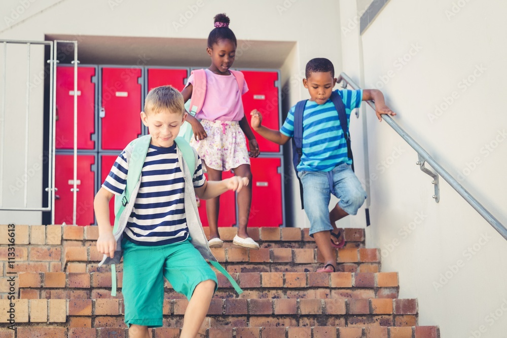 School kids getting down from staircase Stock Photo | Adobe Stock