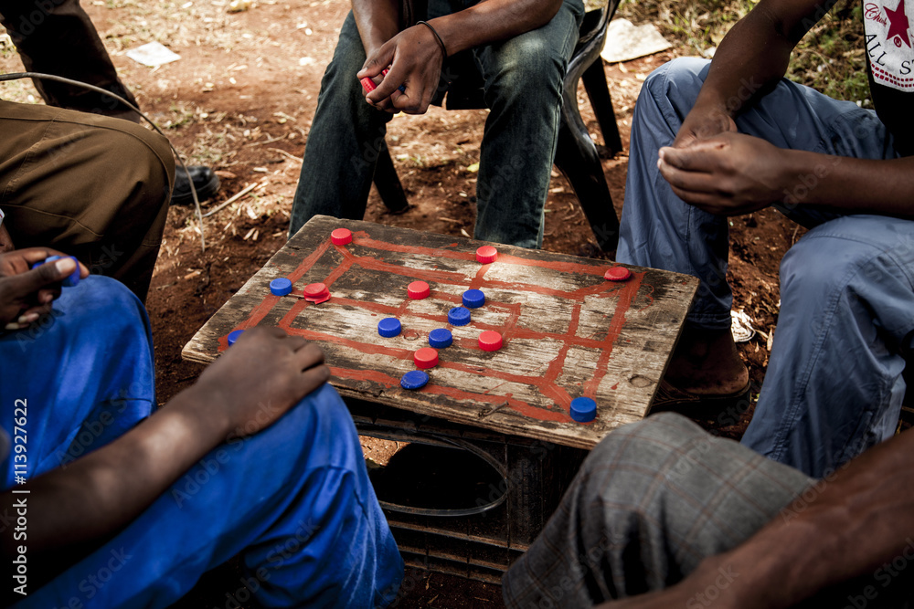 Group of men sitting outdoors, playing Morabaraba in South Africa Stock ...