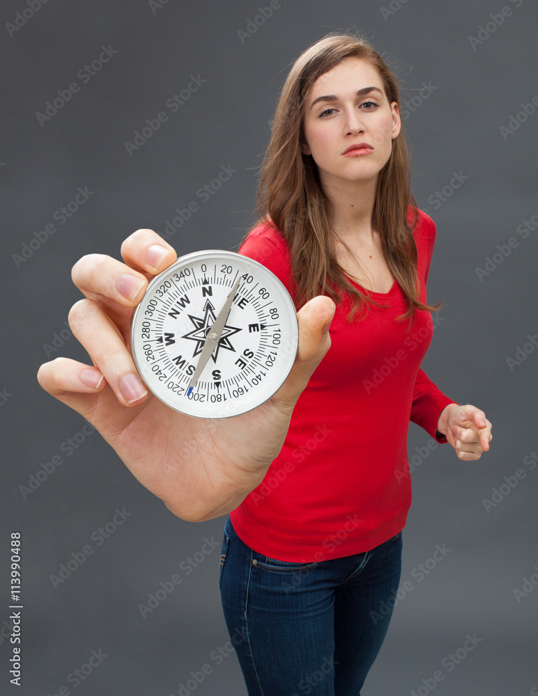 proud young woman with bossy hand gesture showing a compass Stock Photo ...