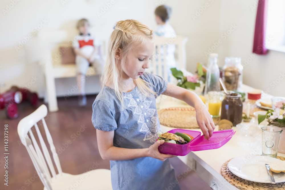 Girl packing lunch box Stock Photo | Adobe Stock