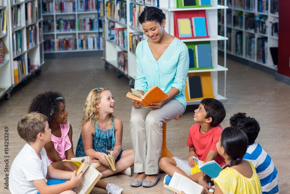 Teacher with students reading books Stock Photo | Adobe Stock