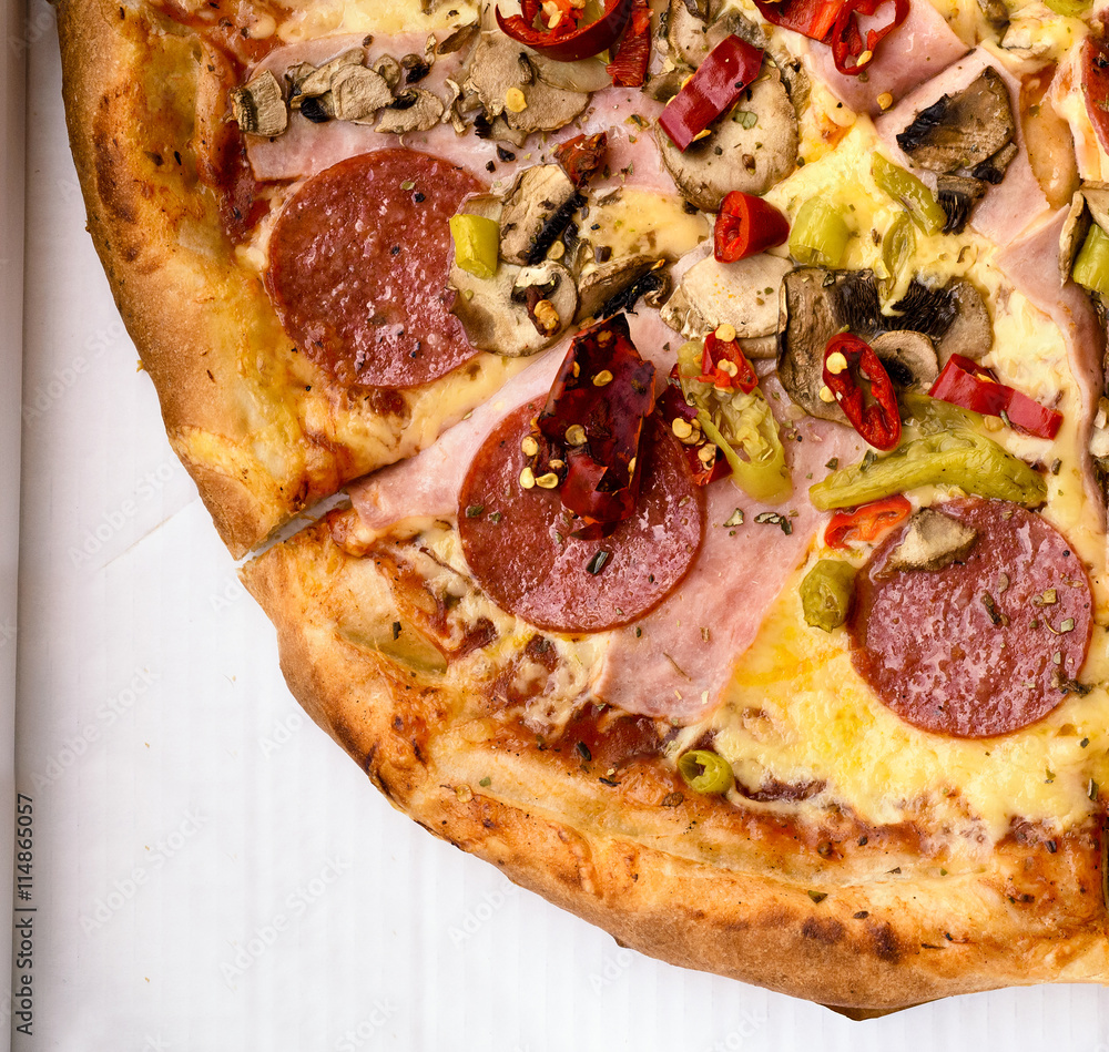 Italian pepperoni pizza with ham, red peppers and cheese Stock Photo ...