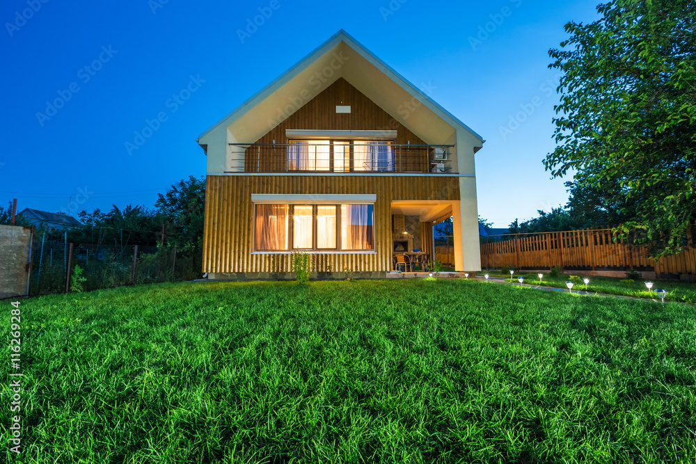 Wooden house with meadow in front of it Stock Photo | Adobe Stock