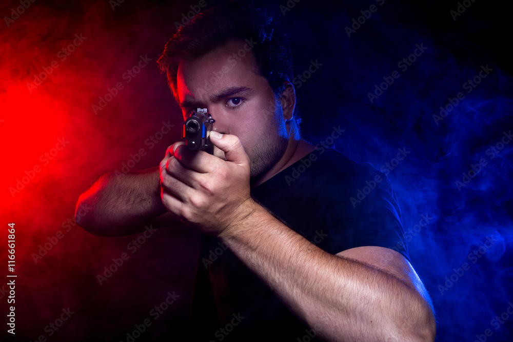 Cop shooting a criminal or terrorist with gun smoke lit by police ...