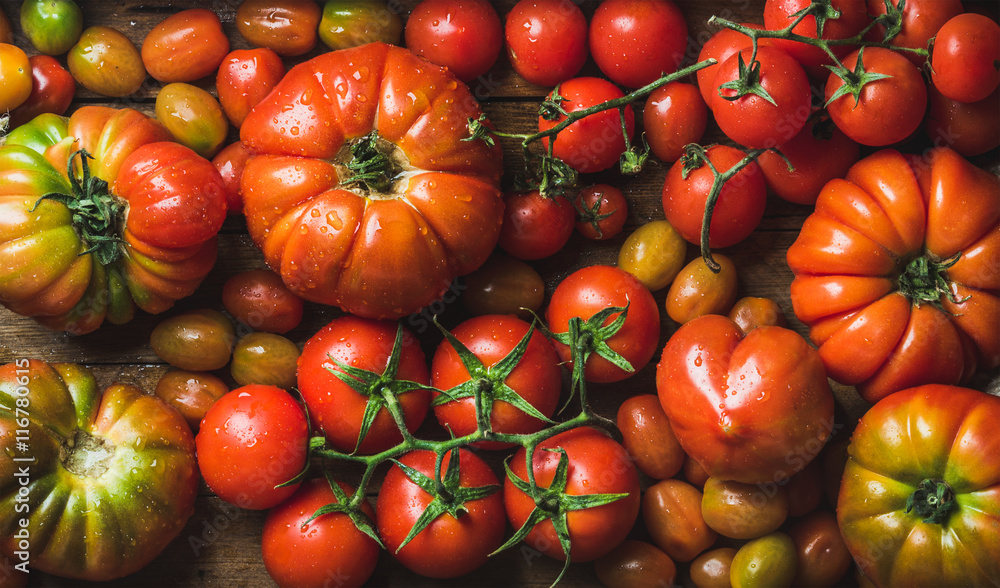 Colorful tomatoes of different sizes and kinds, top view, horizontal ...