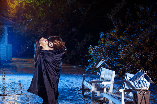 Portrait of a vampire girl drinking blood of victim outdoors Stock ...