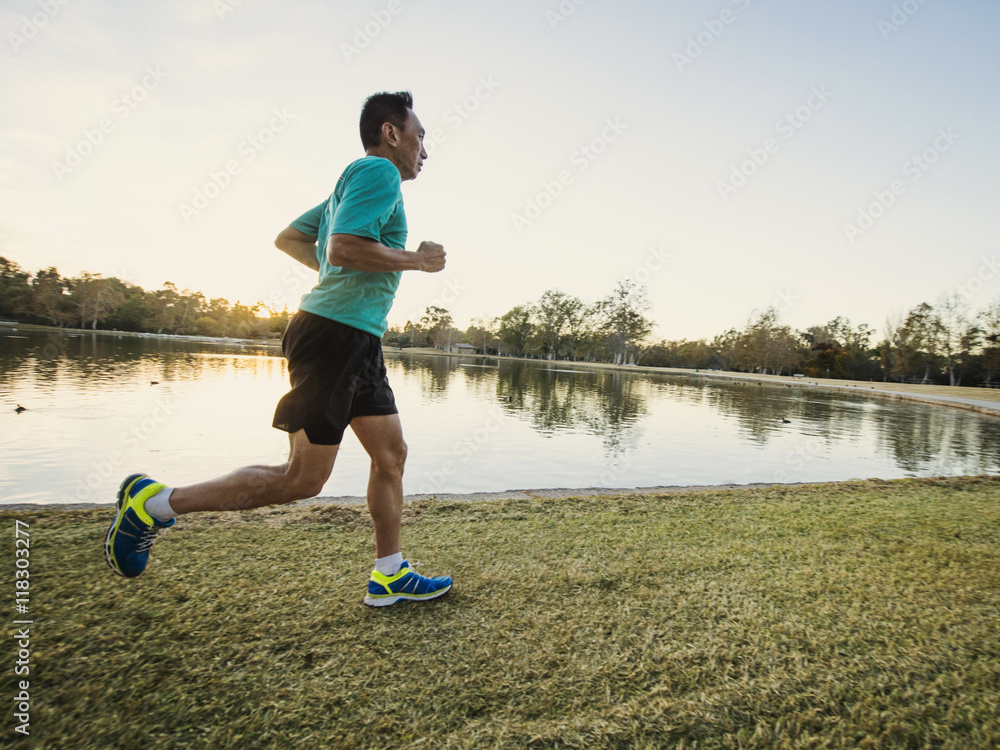 Older Chinese man running in park Stock Photo | Adobe Stock