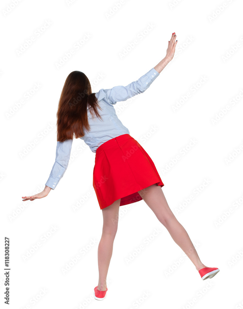 Balancing young woman. or dodge falling woman. Rear view people ...