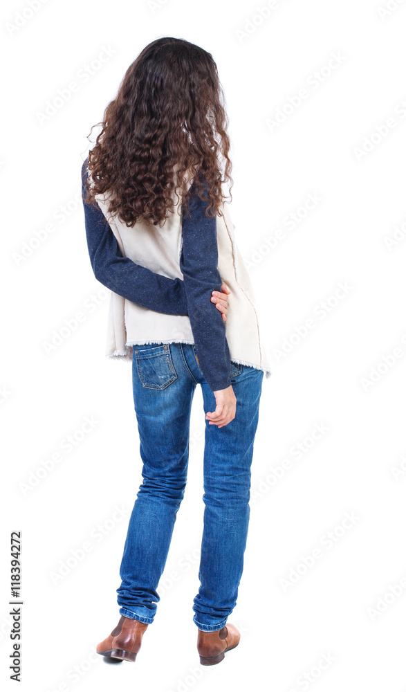 back view of standing young beautiful woman. girl watching. Rear view ...