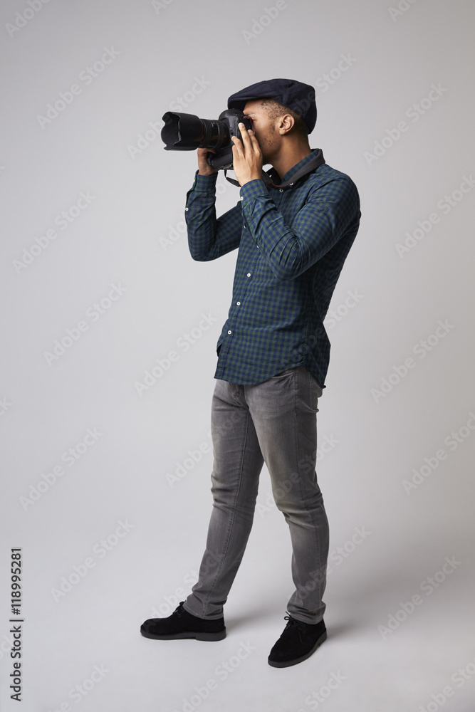 Studio Portrait Of Male Photographer With Camera Stock Photo | Adobe Stock