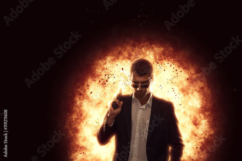 Man in suit with a gun on explosion Stock Photo | Adobe Stock