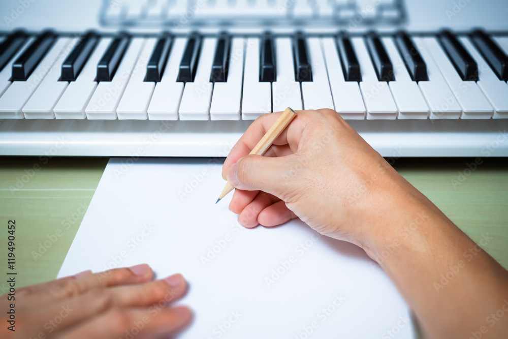 professional composer hands writing songs on blank white paper with ...