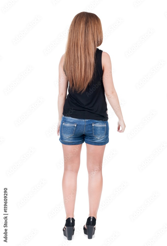 back view of standing young beautiful redhead woman. girl watching ...