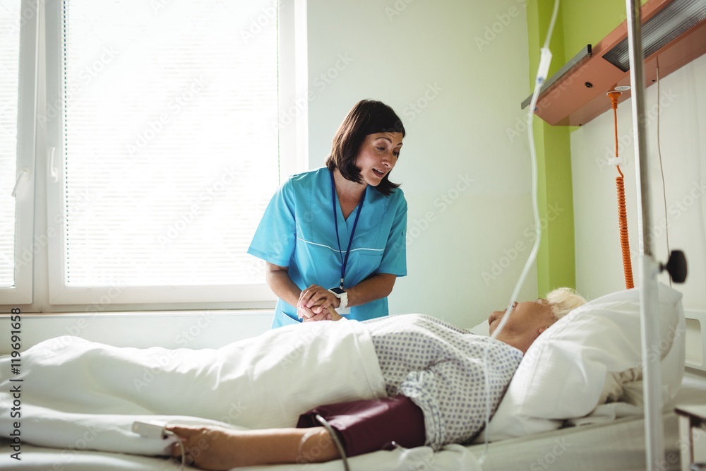 Nurse consoling patient in hospital Stock Photo | Adobe Stock