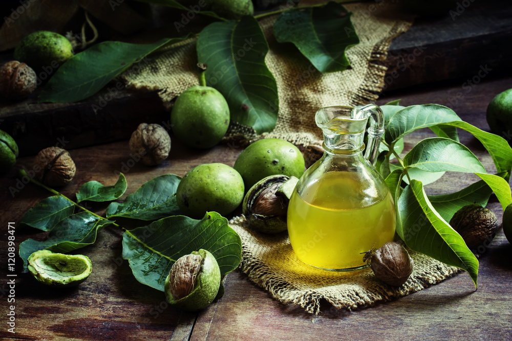 Freshly pressed walnut oil of fresh harvest nuts in shell with l Stock ...
