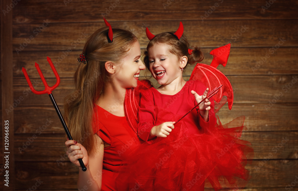 Family mother and child daughter celebrate Halloween in devil co Stock ...