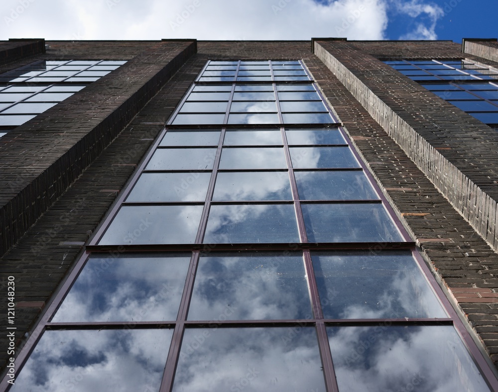 Detailed picture of big and long windows on the brick wall in factory ...