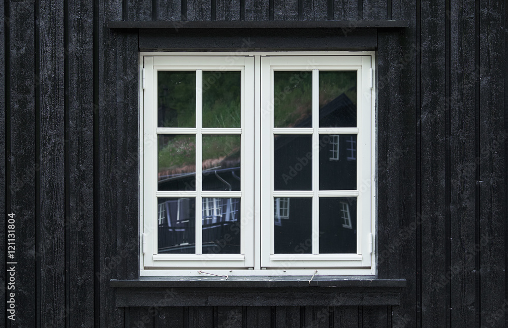 Colonial style casement window of white painted wood in a black tongue ...