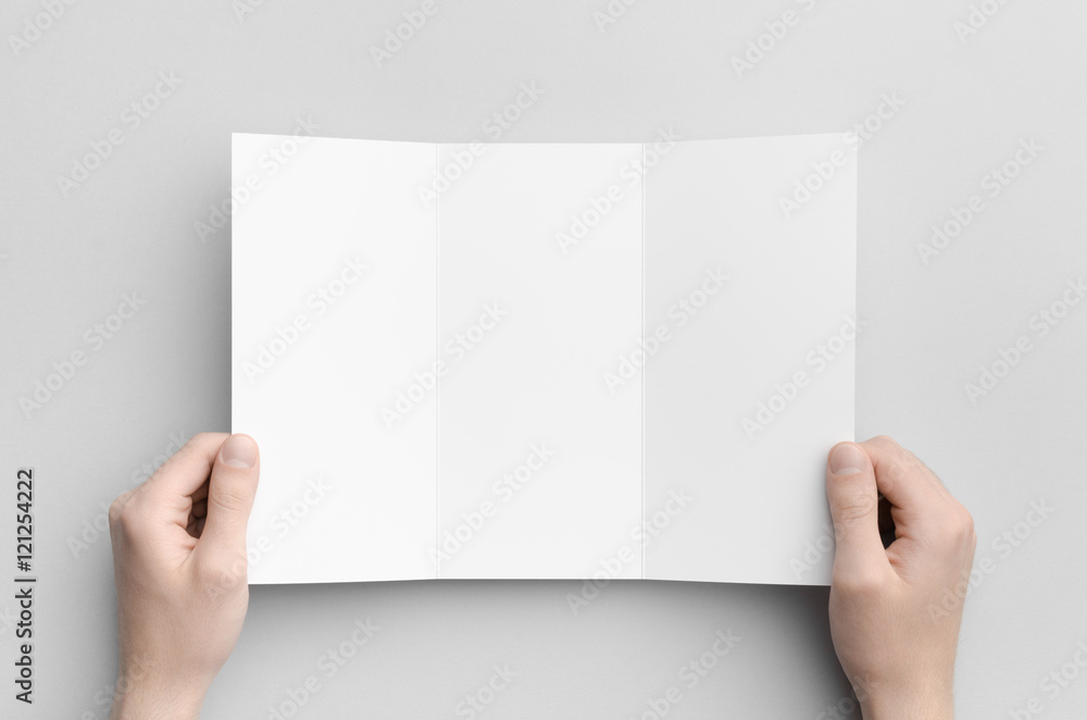 A4 Tri-Fold Brochure Mock-Up - Male hands holding a blank tri-fold on a ...