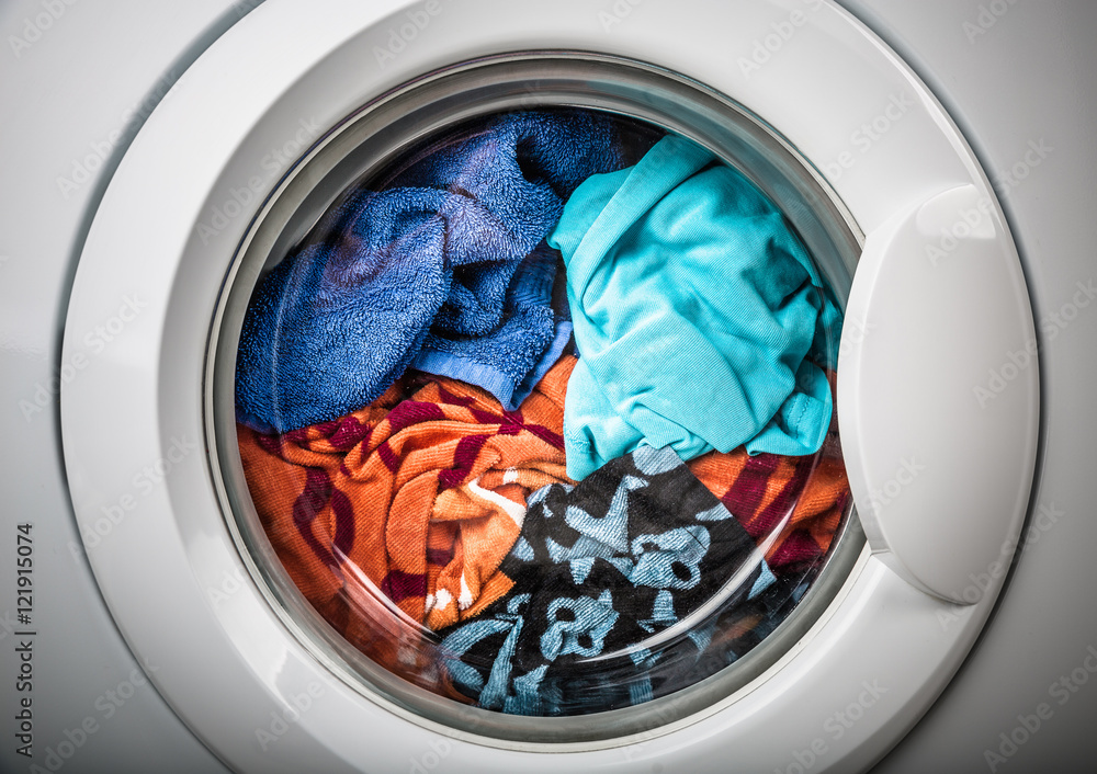 Washing machine with color clothes Stock Photo | Adobe Stock