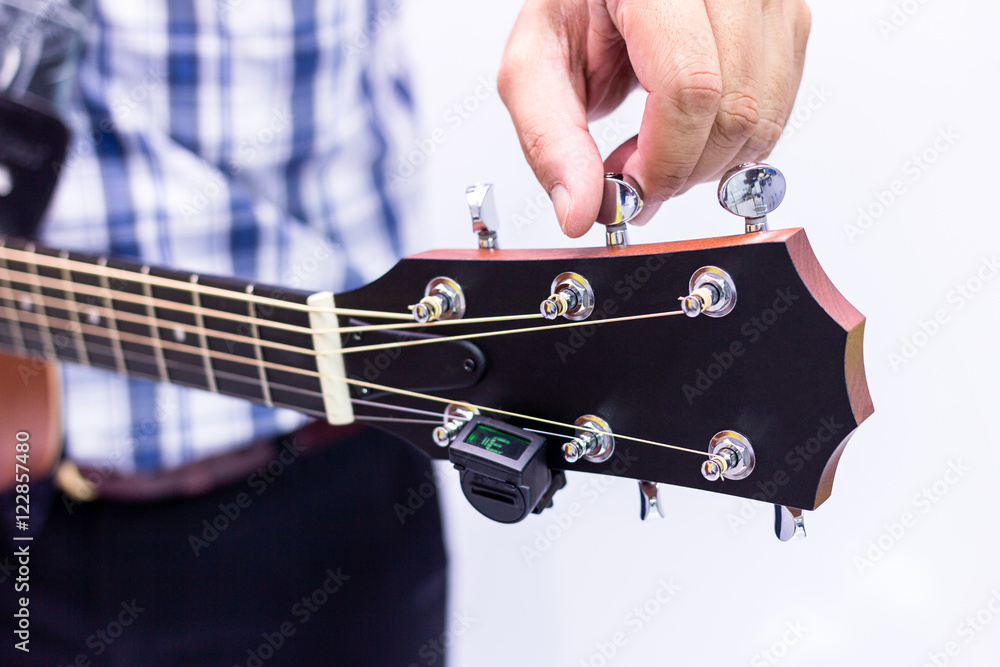 Person tuning a guitar over white background Stock Photo | Adobe Stock