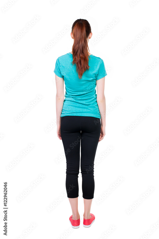 back view of standing young beautiful woman. girl watching. Rear view ...