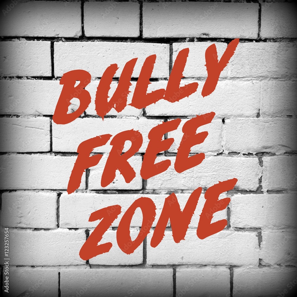 The words Bully Free Zone in red text on a black and white brick wall ...