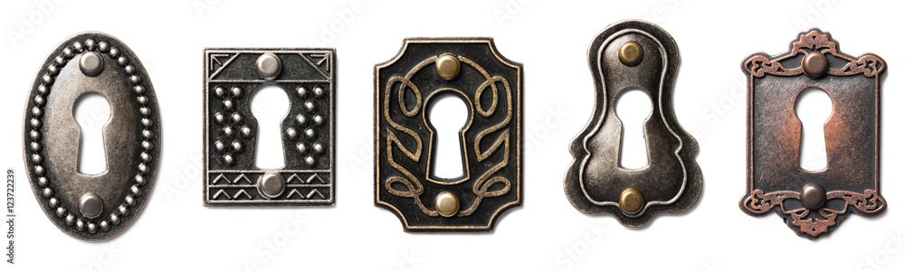 Five patined bronze and brass decorative antique keyholes Isolated on ...