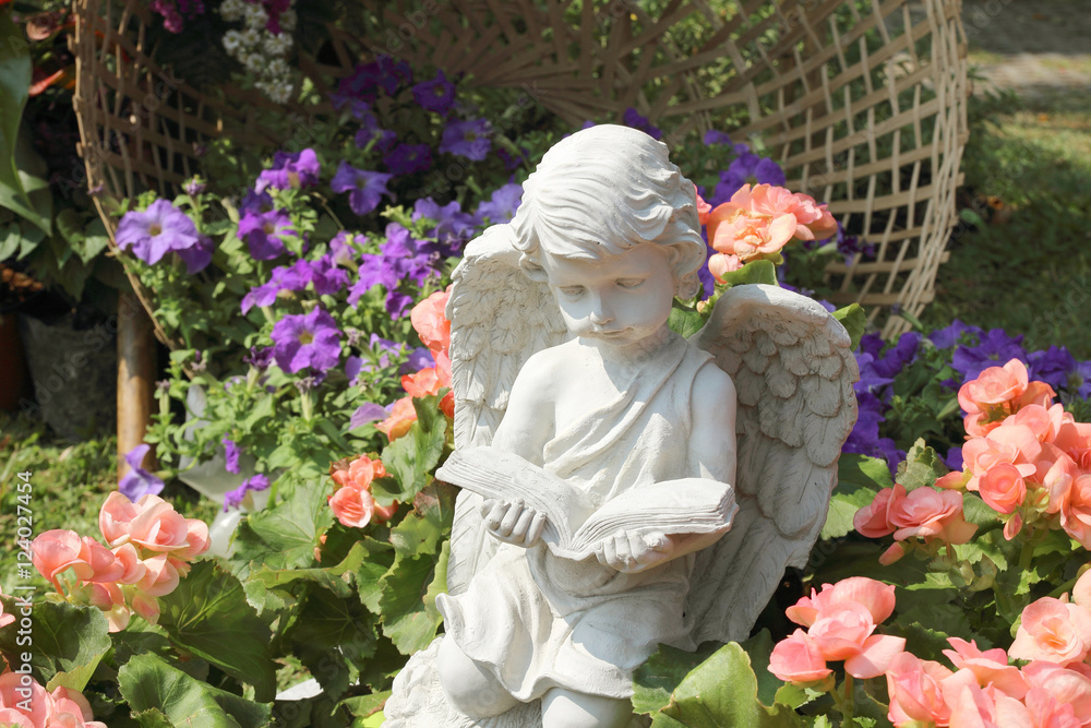 stone angel doll in garden Stock Photo | Adobe Stock