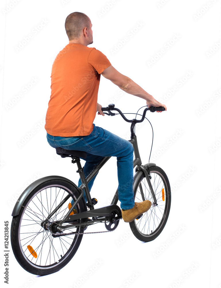 back view of a man with a bicycle. cyclist rides a bicycle. Rear view ...