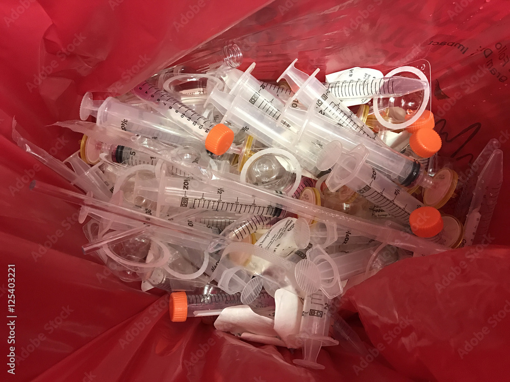 In an HIV testing laboratory, single-use plastic syringes, pipettes ...
