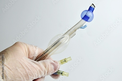 Endobronchial intubation tube with inflated cuffs held in left hand in ...